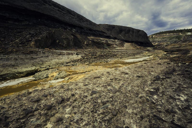 Large Area of Mineral Rocks and Water Under a Clouded Sky Stock Image ...