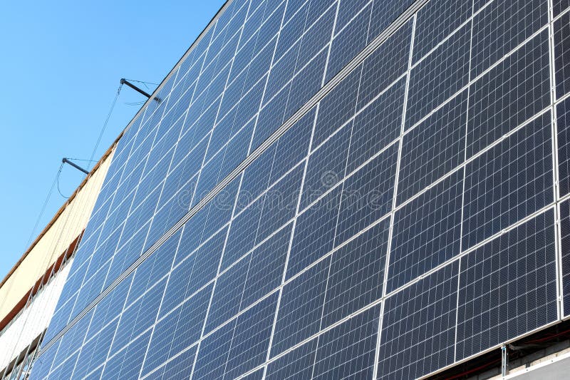 Large Array of Solar Panels Installed on the Side of a Building ...