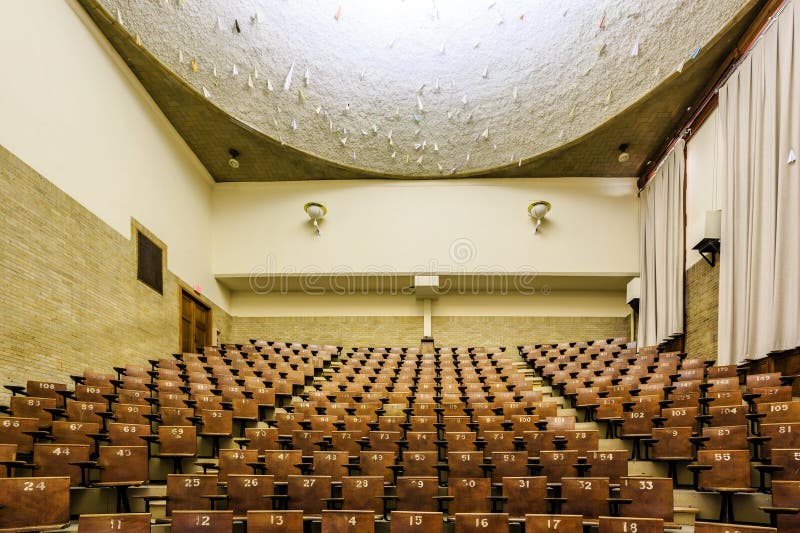 A Large Auditorium with Rows of Wooden Chairs and a Stage Stock Image ...