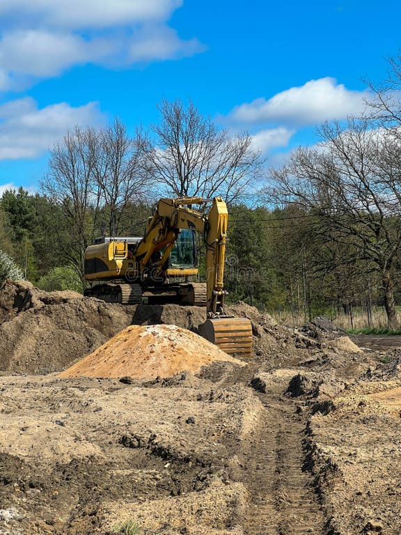 A Large Backhoe Loader Standing on a Pile of Earth Stock Image - Image ...