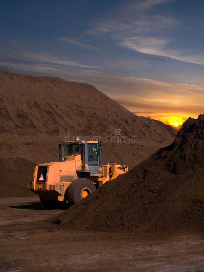 Large Backhoe and Top Soil Piles at Sunset Sunrise Stock Photo - Image ...