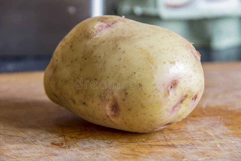 Large Baking Potato on Chopping Board Stock Image - Image of closeup ...