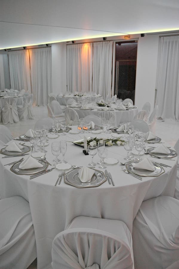 A Large Banquet Hall with Tables and Chairs Set Up for a Wedding ...