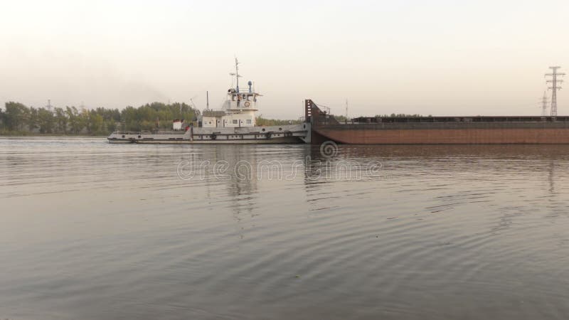 A Large Barge Floats on the River Close-up. a Ship for Carrying Heavy ...