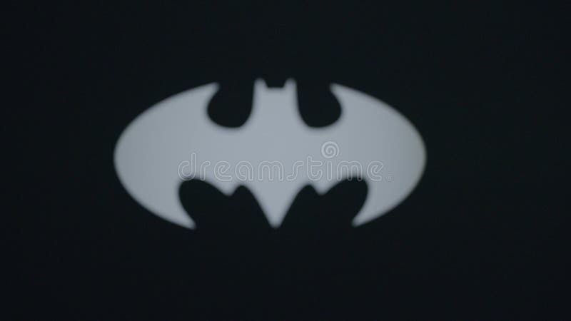 Bat Symbol Projected on a Wall, Showcasing Iconic Imagery in a Dimly ...