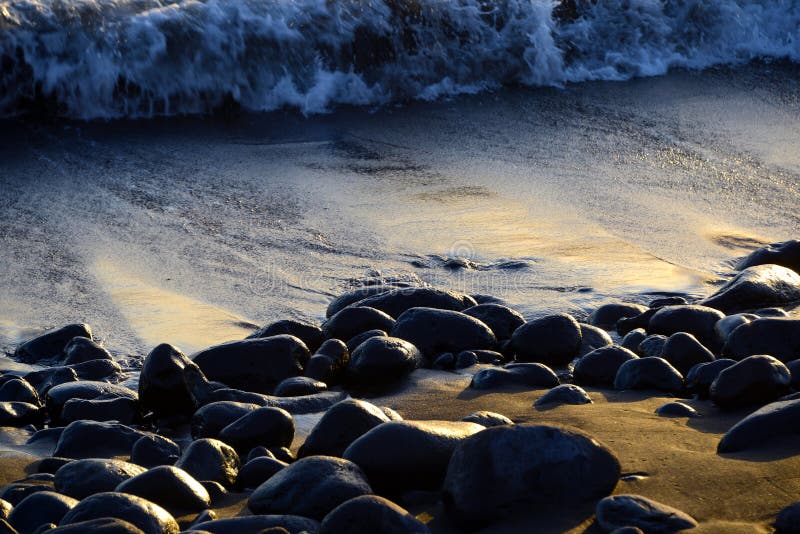 Beach Pebble in Breaking Waves at Dusk Stock Image - Image of beach ...