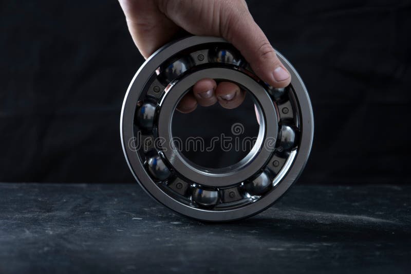 A Large Bearing in a Hand on a Dark Background Stock Photo - Image of ...