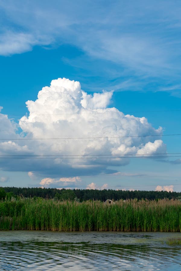 A Large, Beautiful Cloud Has Formed Over the Lake. Spacious Landscape ...