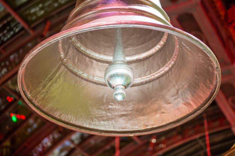 A Large Bell Hanging from the Ceiling Stock Image - Image of ...