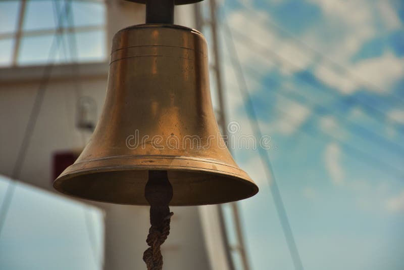 A Large Bell Made of Bronze on the Ship`s Deck with Sky and Clouds ...