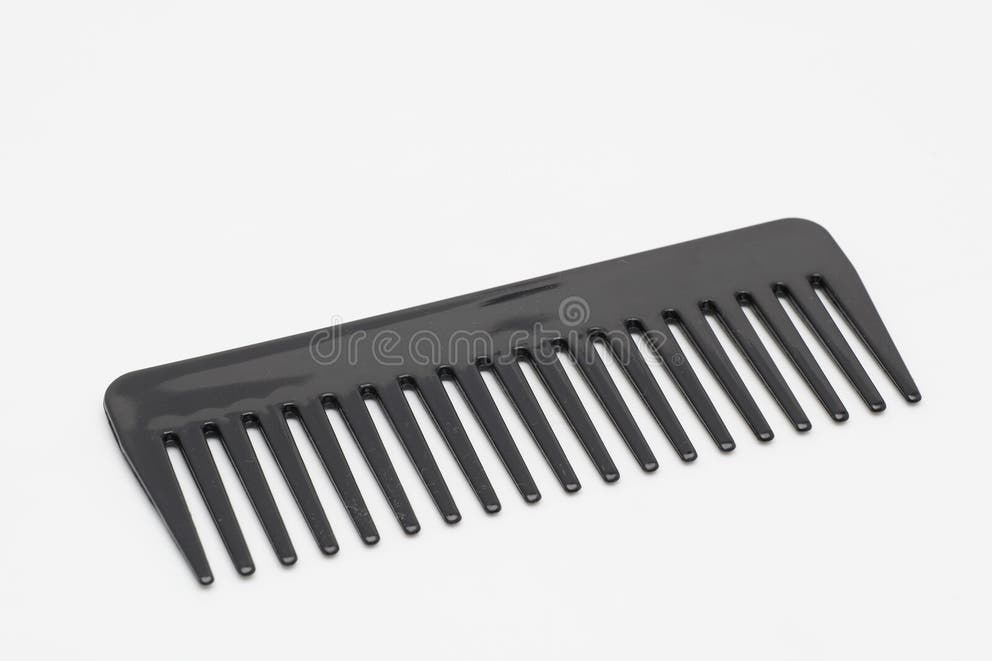 A Large Black Plastic Comb Rotates on a White Background. Stock Photo ...