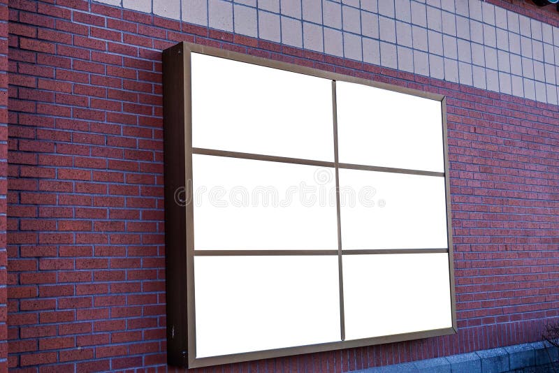 A Large Blank White Sign on a Brick Wall with Six Separate Empty Panels ...