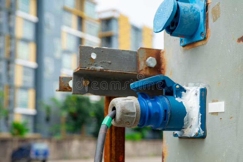A Large Blue Three-phase Power Plug is Plugged into the Socket-outlet ...