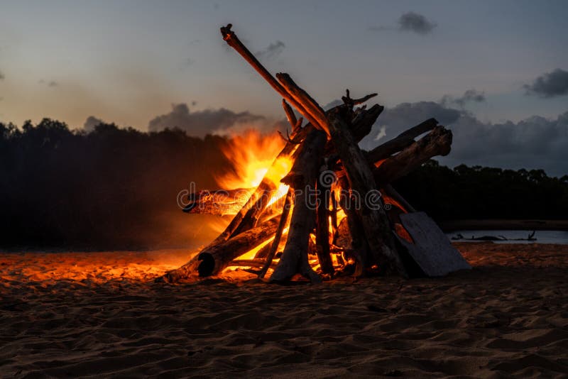 A Large Bonfire on the Beach at Sunset Stock Image - Image of flame ...