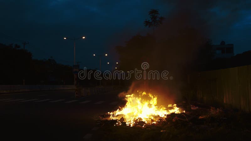 Large Bonfire of Unauthorized Waste Burns on Roadside Edge at Night ...