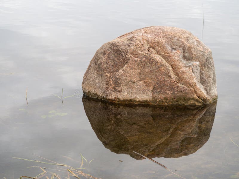 Large Boulder on Lake or River Stock Photo - Image of problems, reeds ...