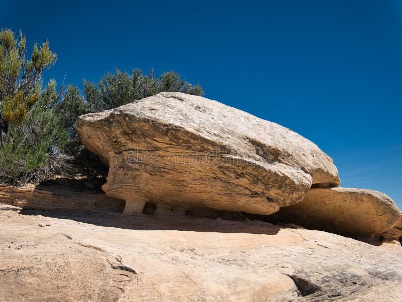 Large Boulder on Natural Stone Columns Stock Photo - Image of shrubs ...