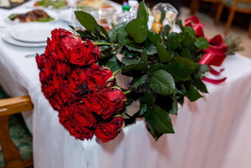 A Large Bouquet of Red Roses on a Table in a Restaurant Stock Image ...