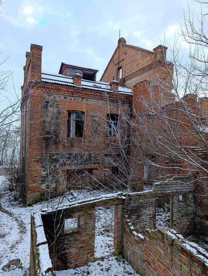 A Large Brick Building with a Lot of Snow on the Ground Stock Image ...