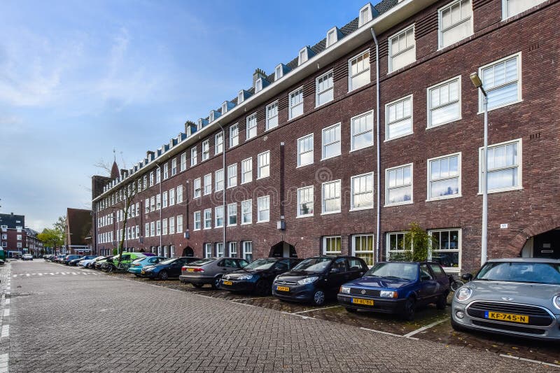 A Large Brick Building with Many Cars Parked in Front Editorial ...