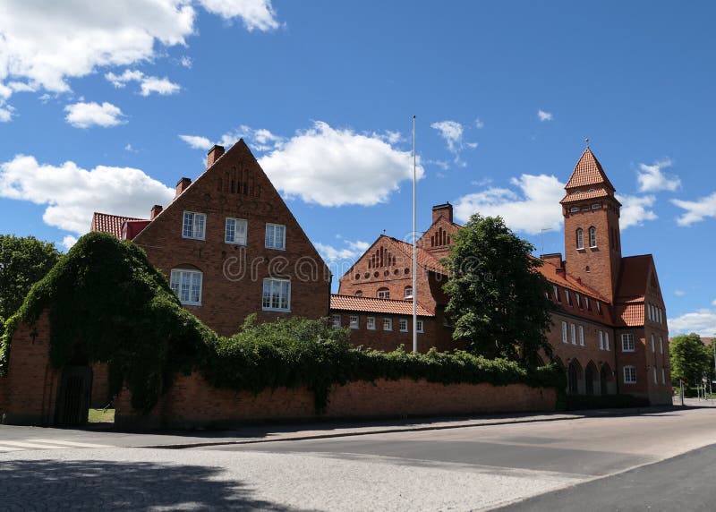 A Large Brick Building on the Side of a Road Stock Image - Image of ...