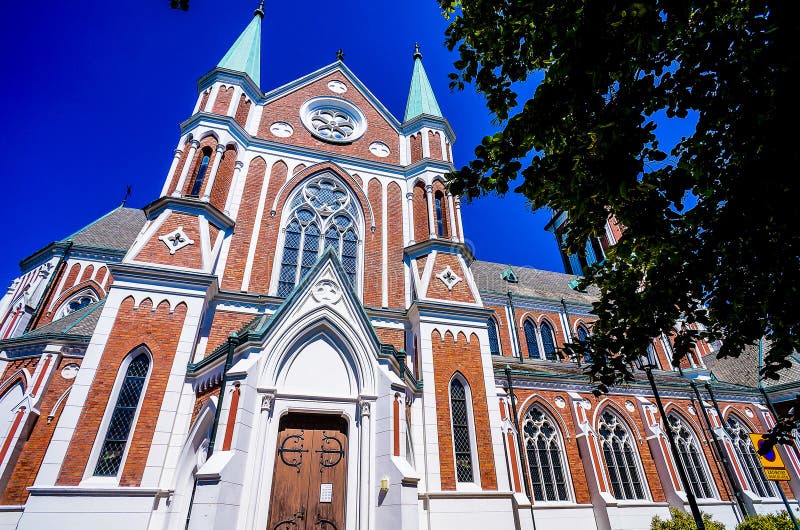 A Large Brick Building with a Steeple and a Clock Tower Stock Image ...