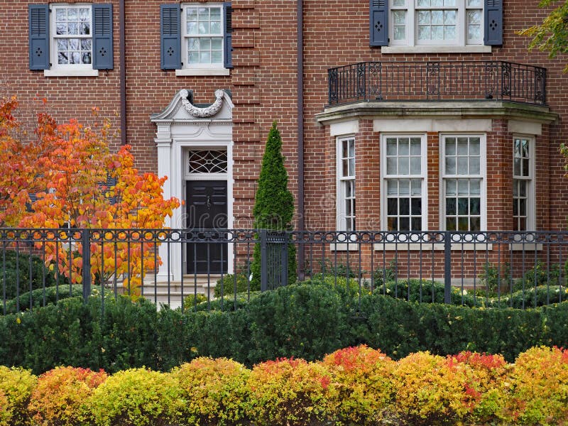 Large Brick House with Iron Fence Stock Image - Image of fall, iron ...
