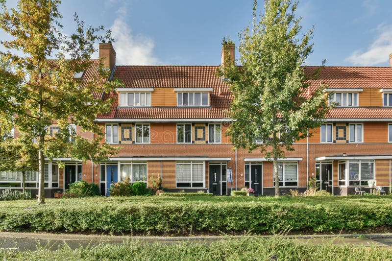 A Large Brick House with Trees in Front of it Editorial Image - Image ...