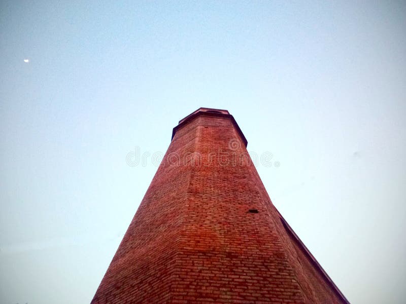 A Large Brick Tower with Side of a Building Stock Image - Image of ...