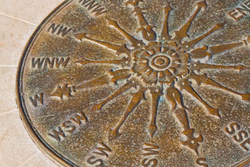 A Large Bronze Compass Based on the Port Pier. Stock Photo - Image of ...