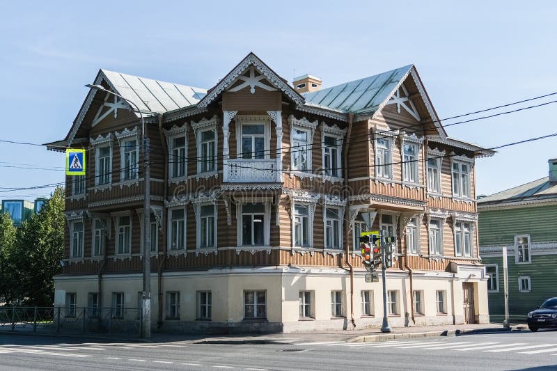 A Large Brown Building with a Blue Sign on the Side Stock Image - Image ...