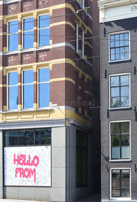 Large Brown Building with Multiple Windows and an Advertisement on the ...