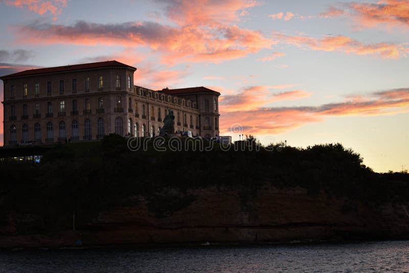A Large Building on the Beach at Sunset Stock Photo - Image of beach ...