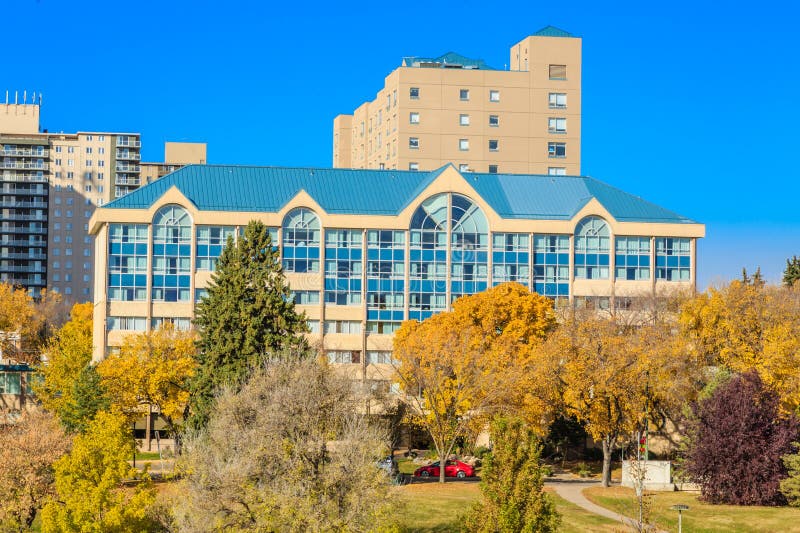 A Large Building with a Blue Roof and Many Windows Stock Image - Image ...