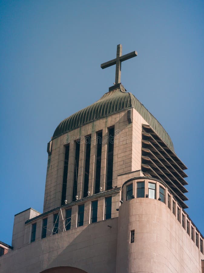 A Large Building with a Cross and a Clock in Front Stock Photo - Image ...
