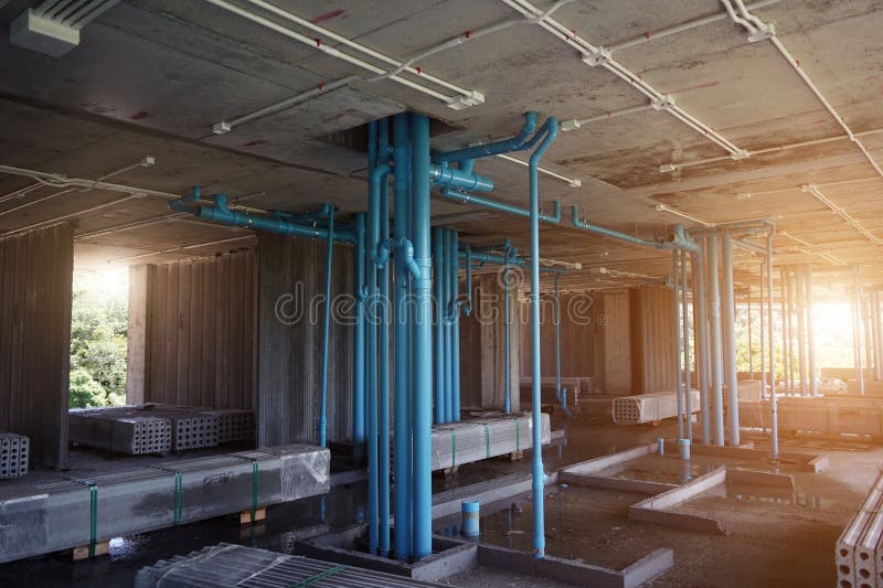 A Large Building Currently Under Construction that Has Many Blue Pipes ...