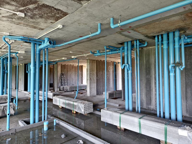 A Large Building Currently Under Construction that Has Many Blue Pipes ...