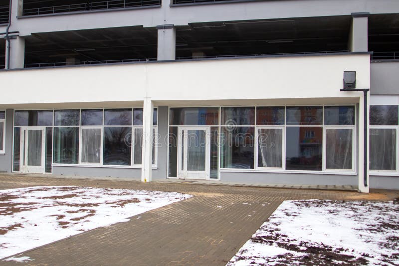 A Large Building that Features Numerous Windows and Multiple Doors ...