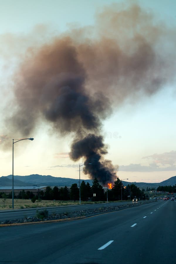 Large Building Fire with Smoke Cloud in the Distance Down the Street ...