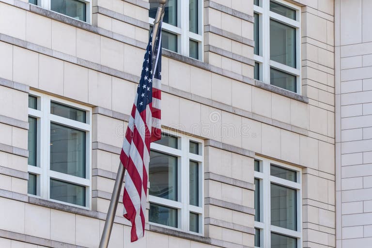 A Large Building with a Flagpole in Front of it Stock Image - Image of ...