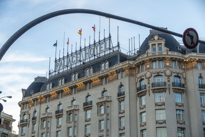 A Large Building with Flags and a Traffic Light in Front Editorial ...