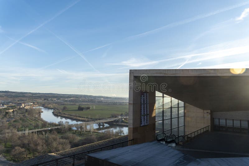 A Large Building with Numerous Windows that Overlook a Scenic River ...