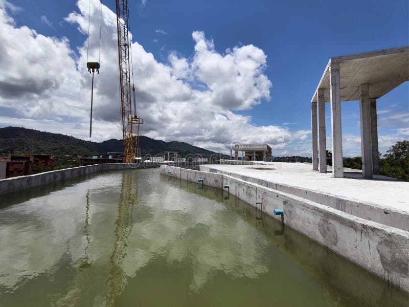 Large Building with a Roof Pool of Water Under Construction Stock Photo ...