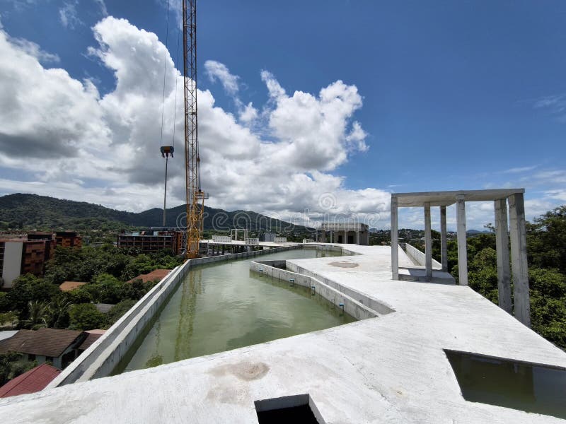 Large Building with a Roof Pool of Water Under Construction Stock Photo ...