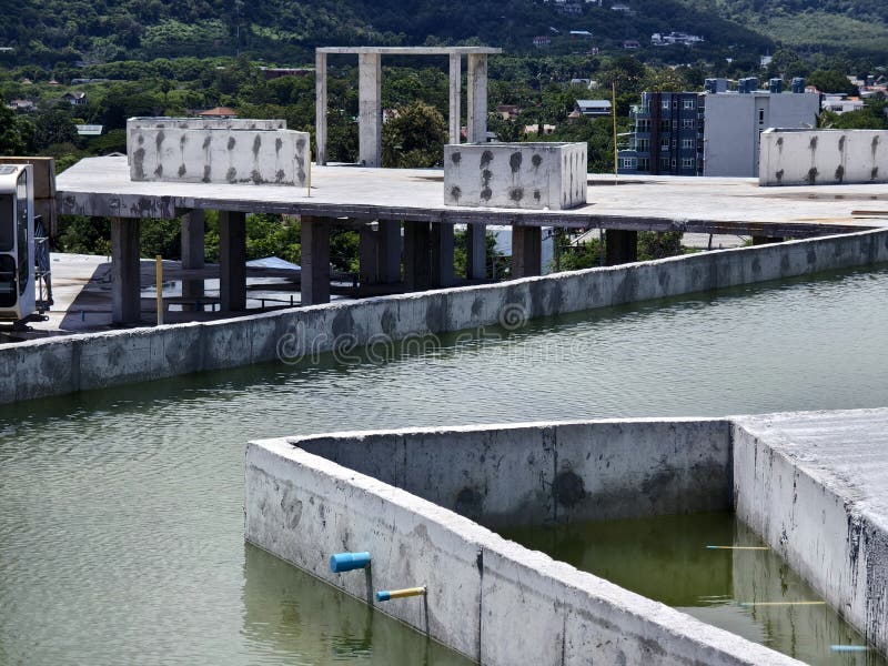 Large Building with a Roof Pool of Water Under Construction Stock Photo ...