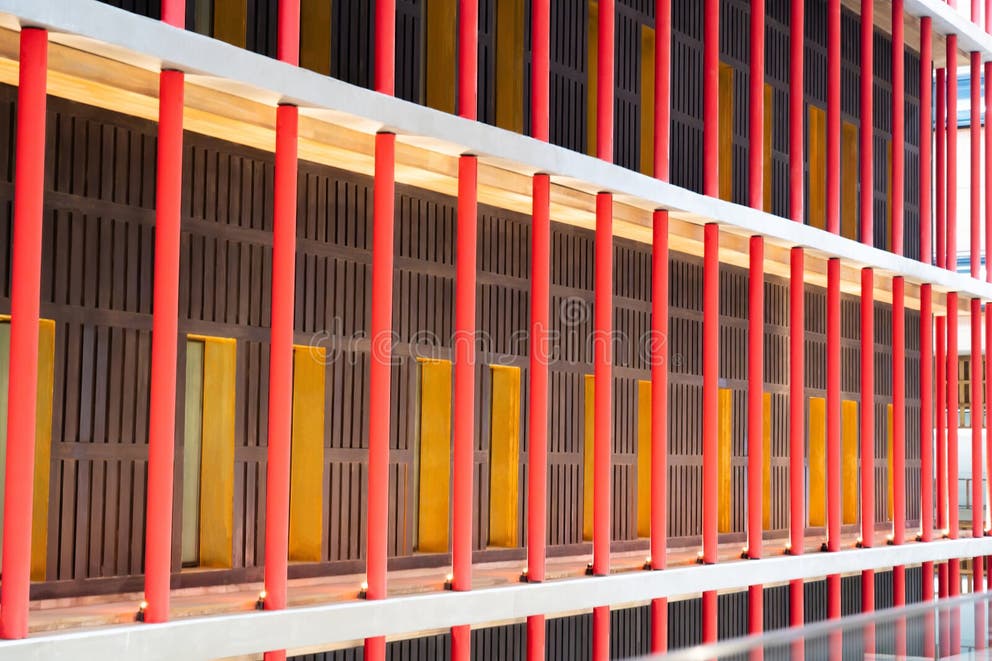 A Large Building Surrounded by Rows of Sturdy Red Pillars Stock Image ...