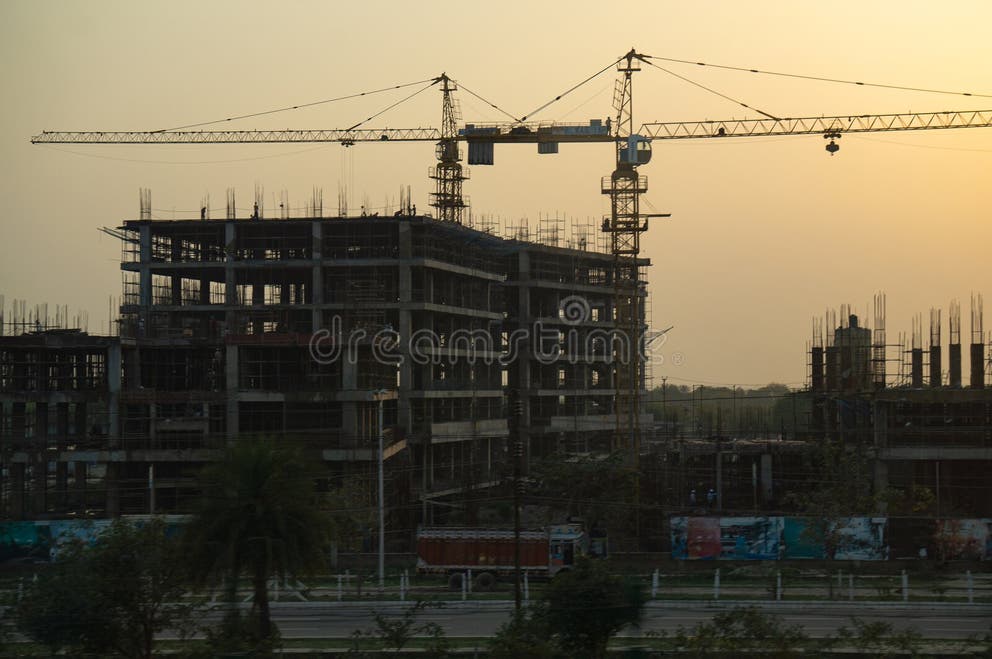 A Large Building is Under Construction and Has Two Large Cranes ...