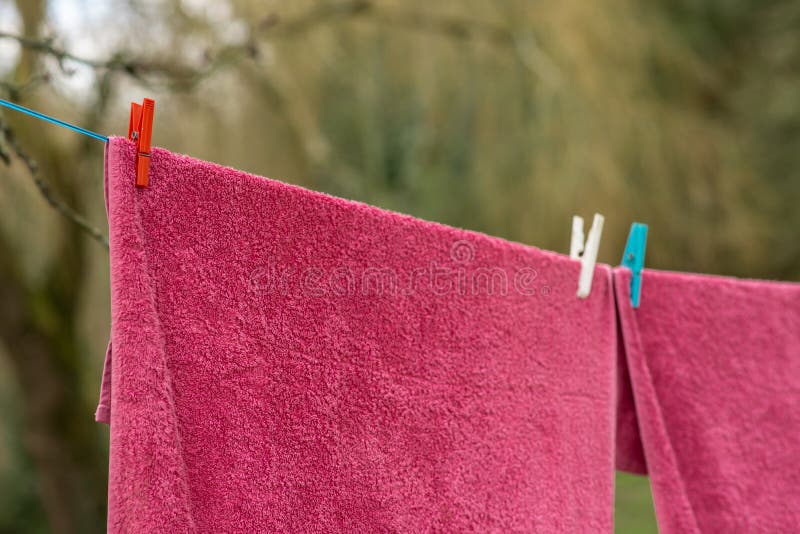 A Large Burgundy Towel Hangs on a Rope. Rope Drying Stock Image - Image ...
