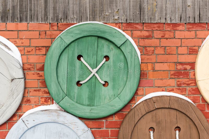 Large Buttons on a Red Brick and Wooden Wall Stock Image - Image of ...