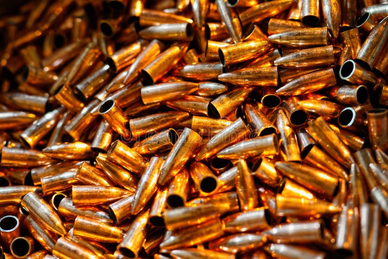 Pile of Copper Bullet Shells and Turning Wheel at Production Line Stock ...